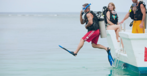 Why do scuba divers fall backwards off boats to enter water