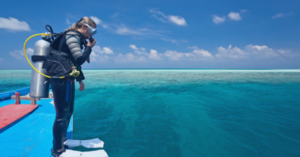 Why do scuba divers fall backwards off boats to enter water